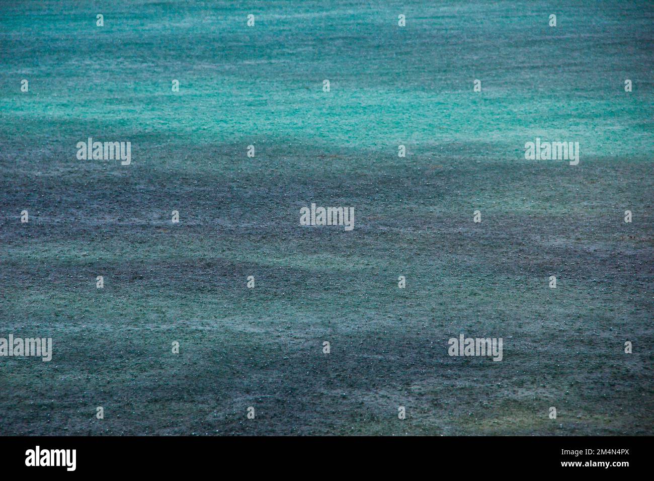 The rain dropping in the blue ocean water Stock Photo - Alamy