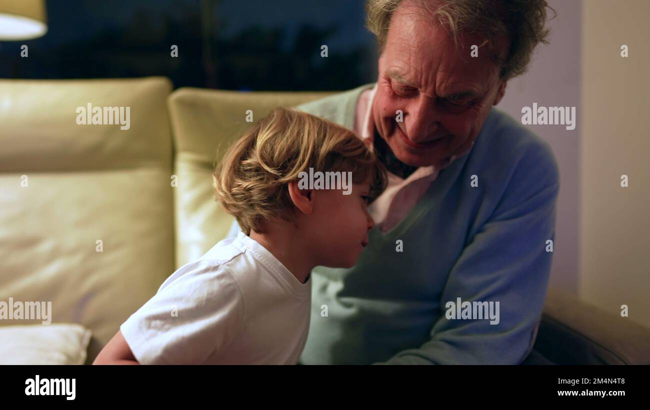 Grandfather and grandson hanging out together in living room couch ...