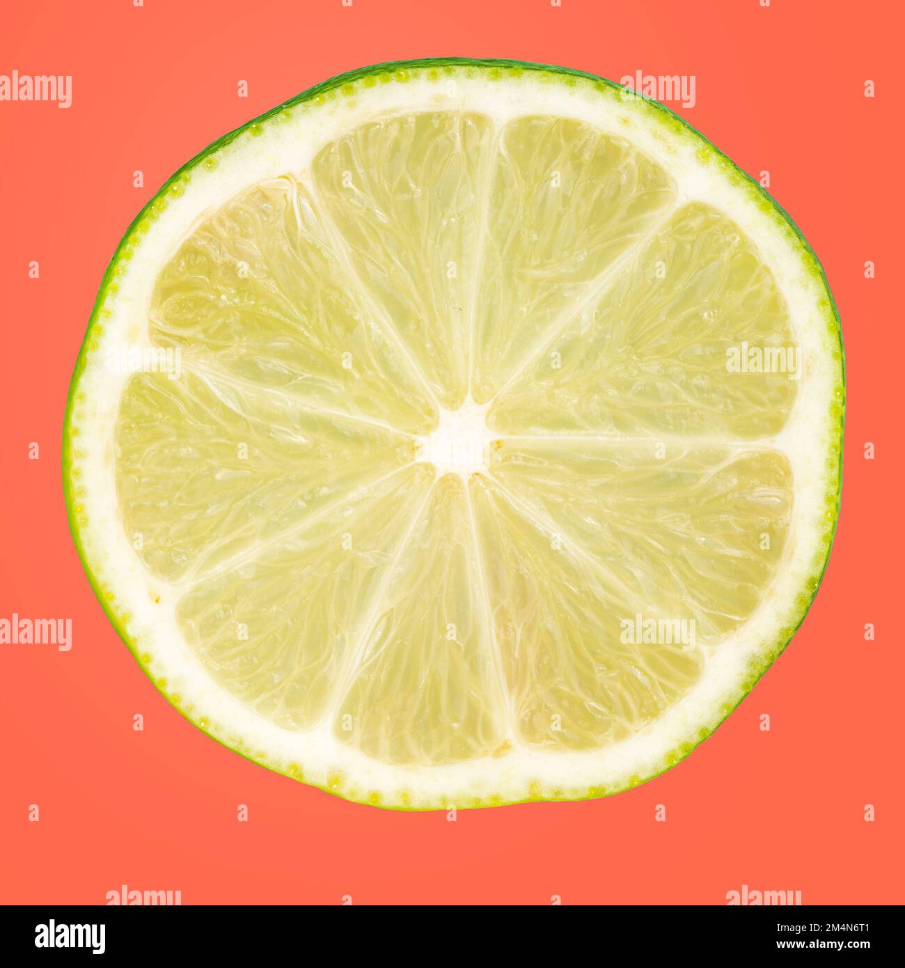 A slice of lime isolated on blue background Stock Photo - Alamy