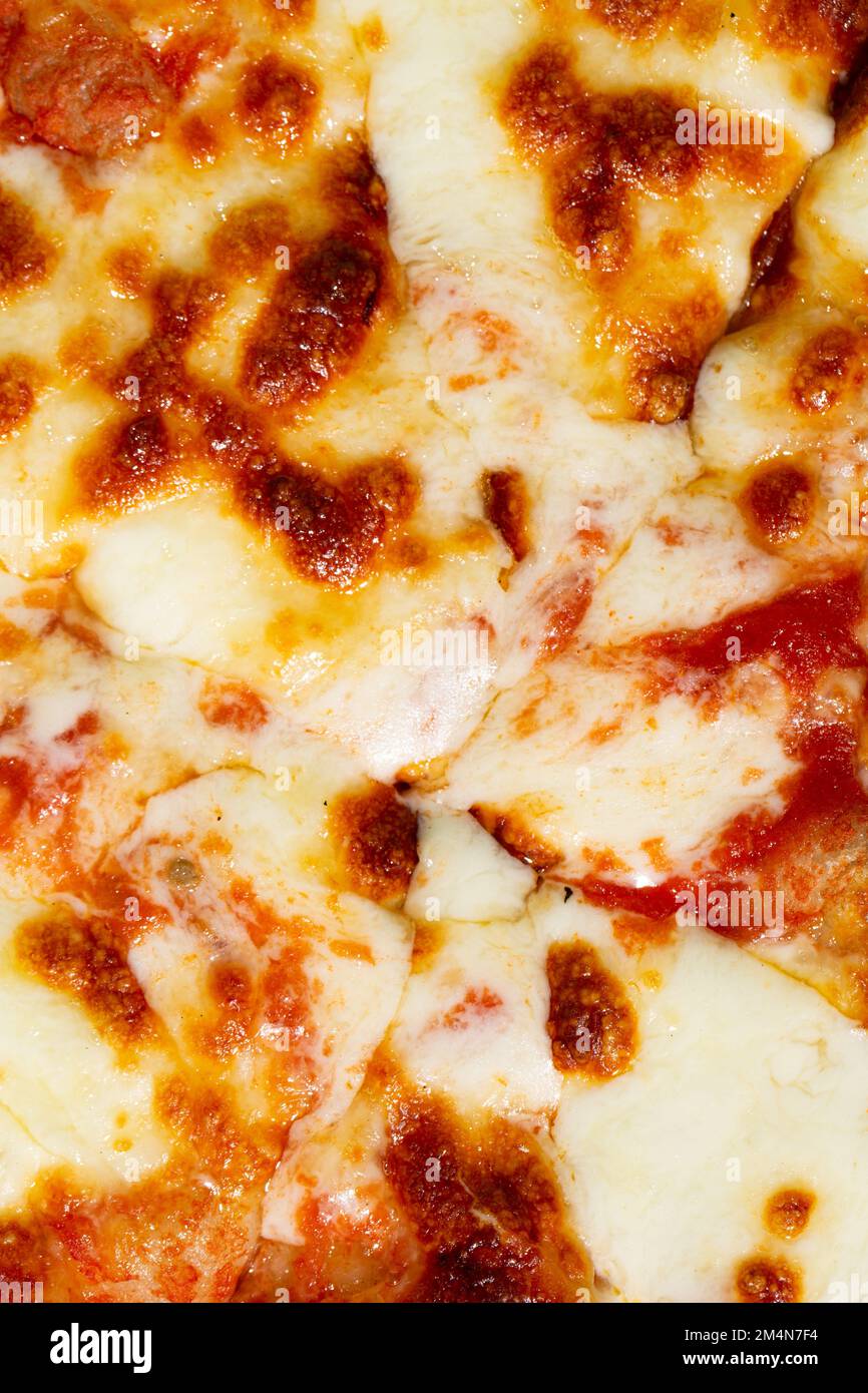 Pizza with mozzarella cheese texture as background. A close shot of a ...
