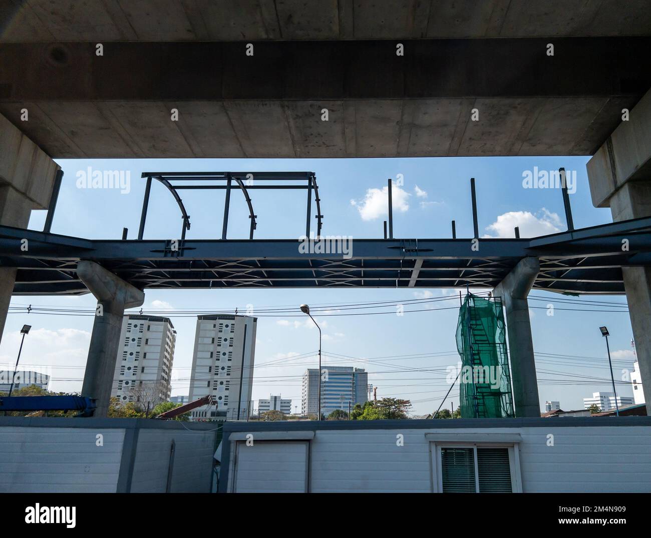 The unfinished metal frame of the sky walks bridge along the railway ...