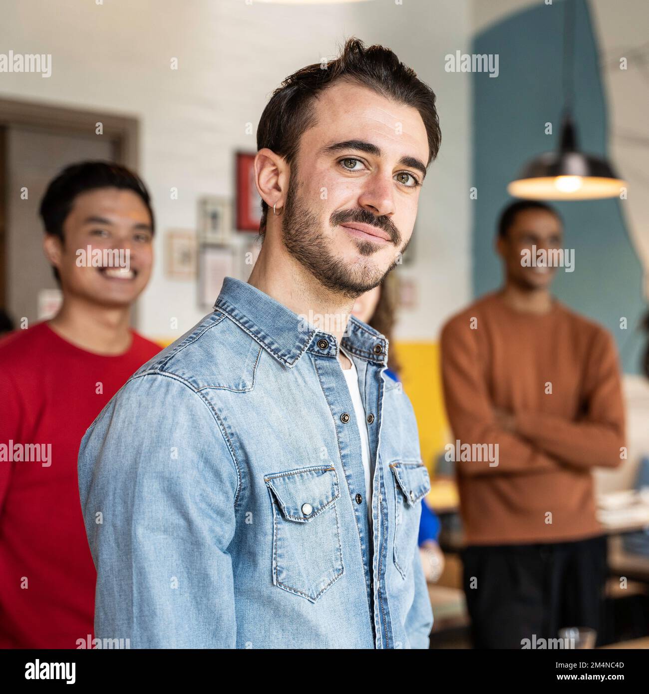 Portrait of young student looking at camera during leisure activity in ...