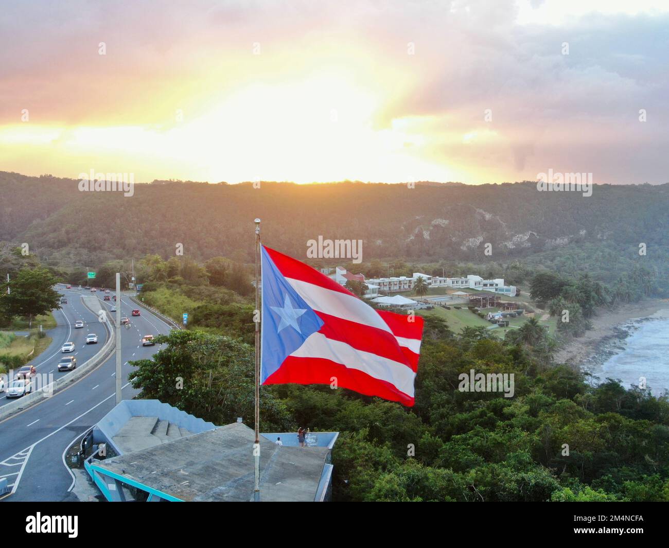 An aerial closeup shot of the Flag of Puerto Rico waving in the air at ...