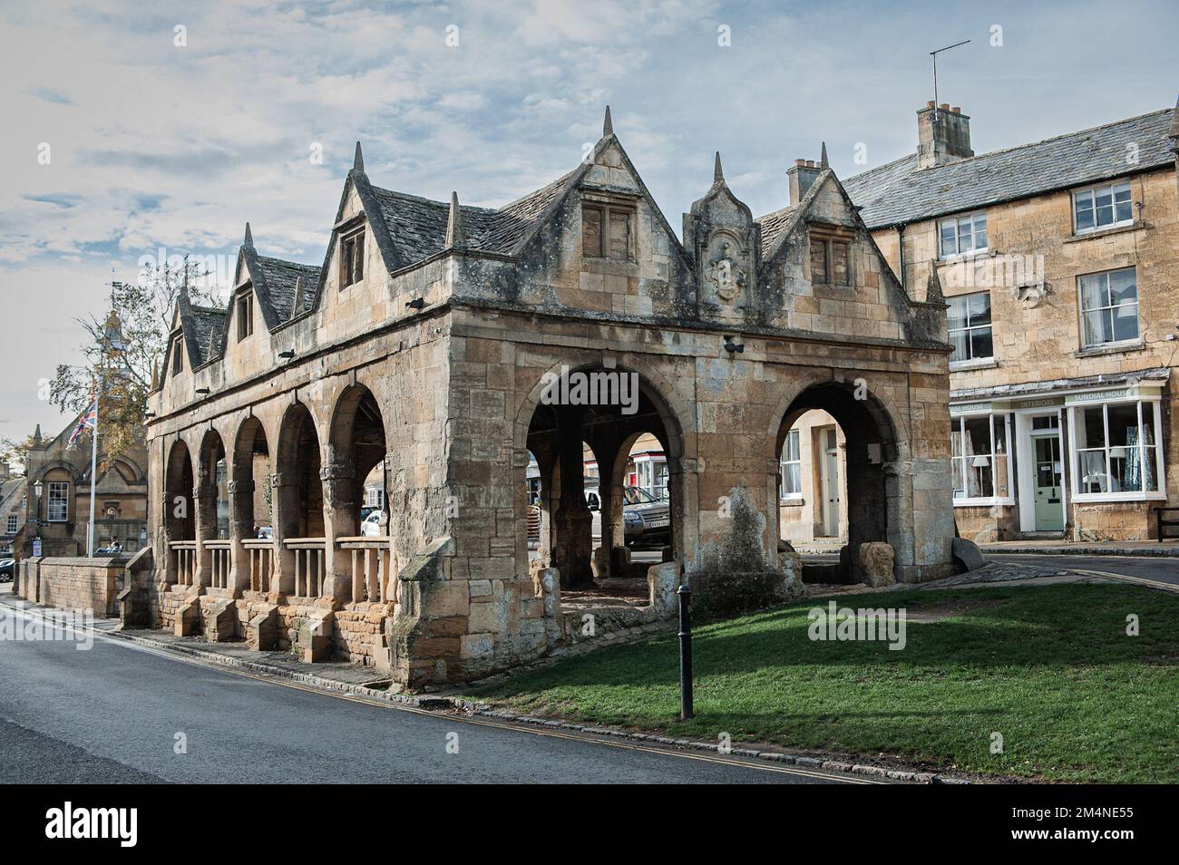 An old stone building with arched arches on a street corner Stock Photo ...