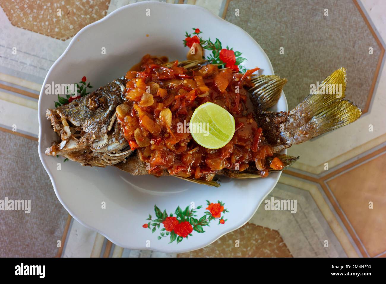 Baked fish with a hot salsa Stock Photo - Alamy