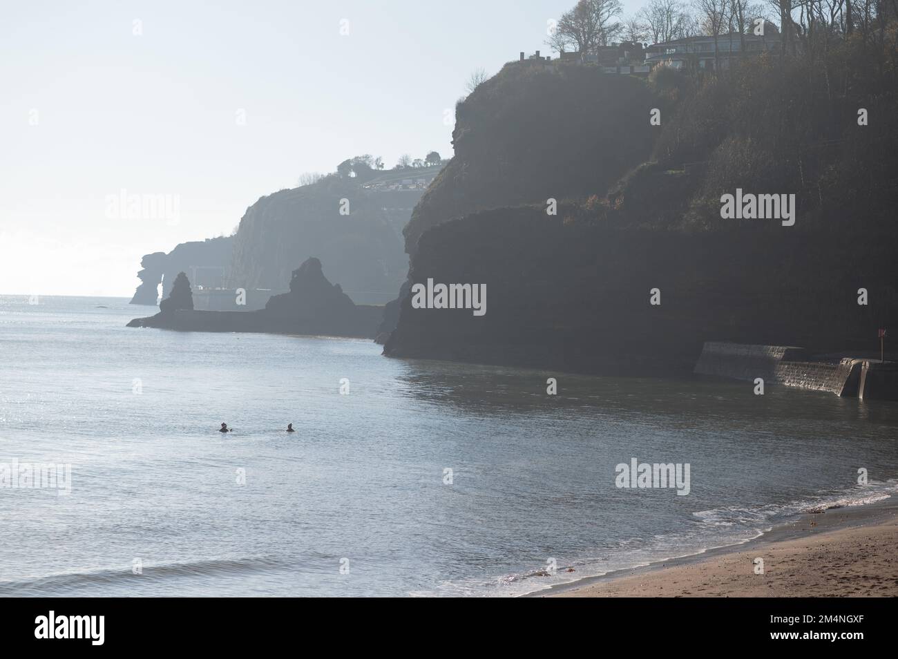 Two people in cold winter sea at low light silhouette Stock Photo - Alamy