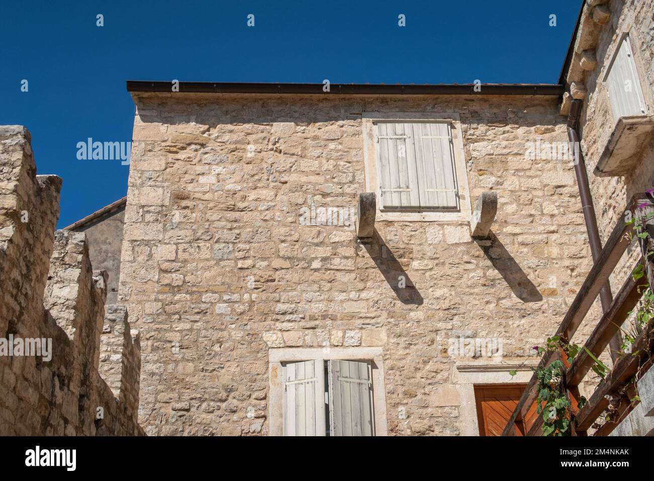 Old medieval wall with wooden window shutters in Split in Croatia ...