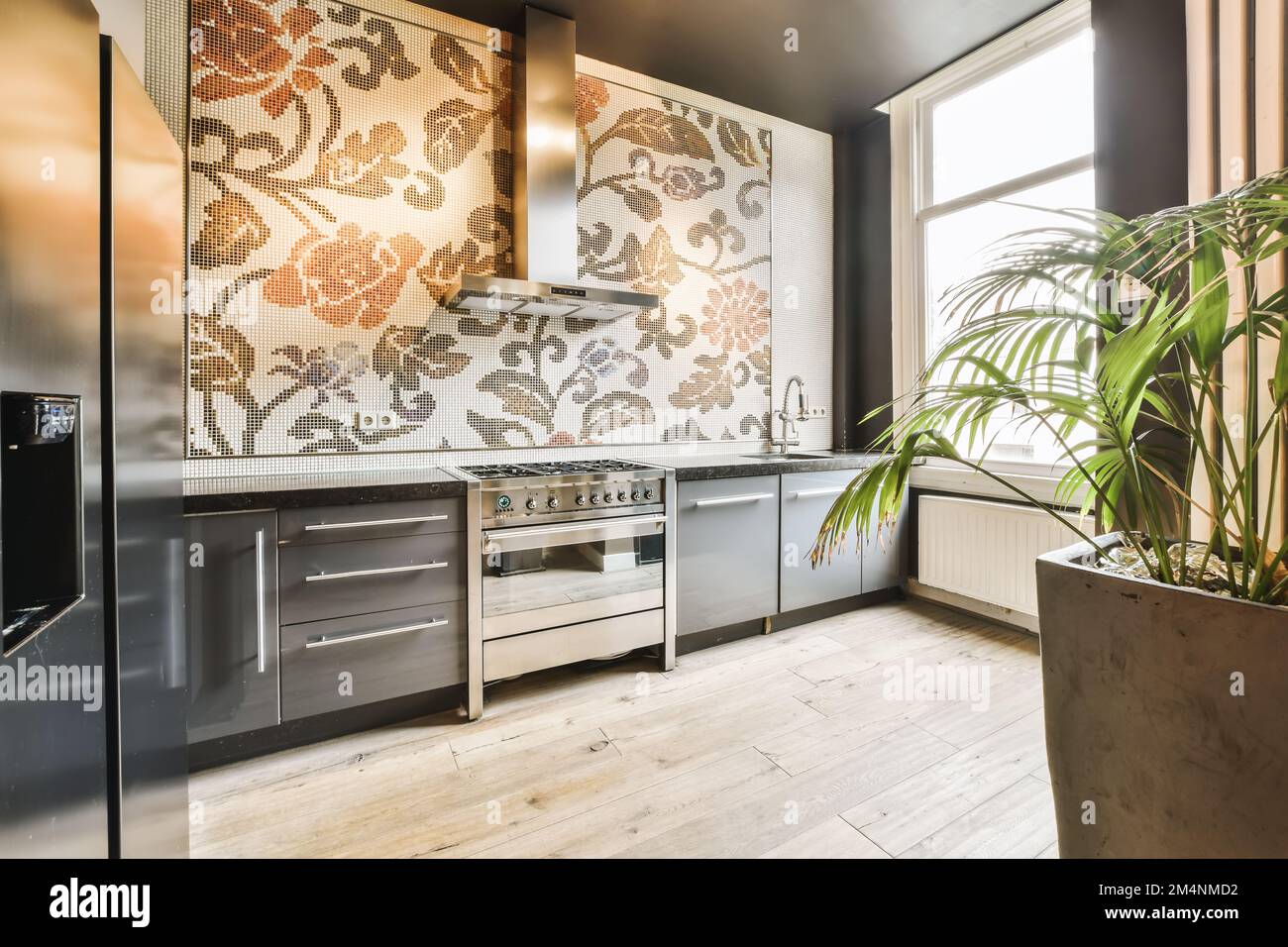 a kitchen with an oven, sink and dishwasher in the photo is taken from ...