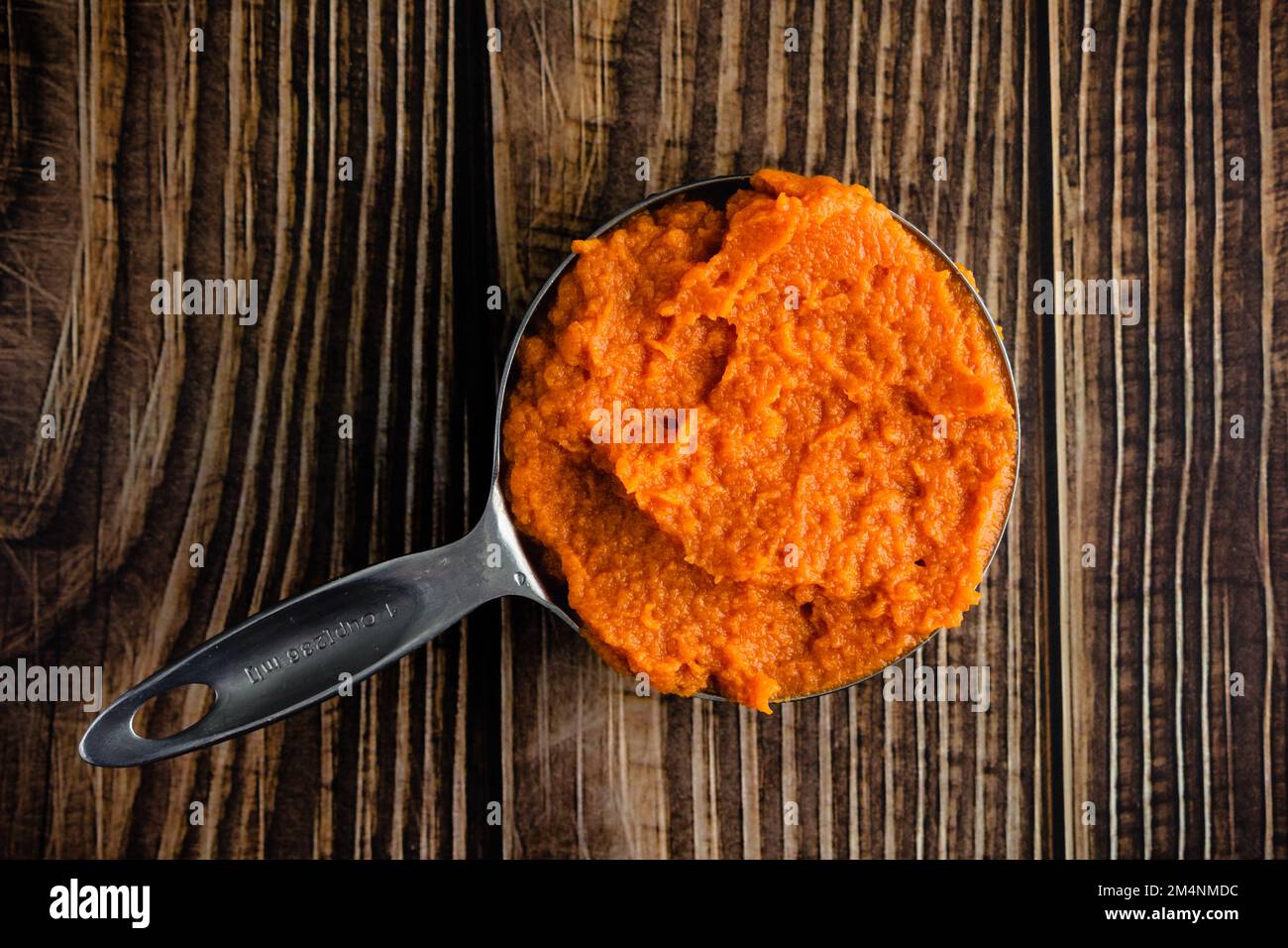 Measuring Cup Full of Canned Pumpkin Puree: Metal measuring cup filled ...