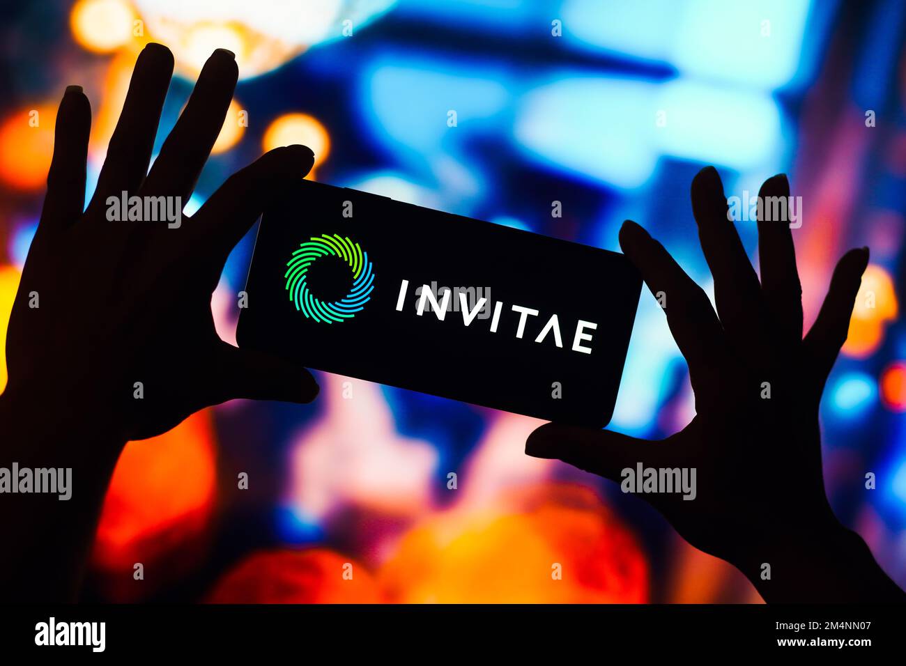 In this photo illustration, the Invitae logo is displayed on a ...