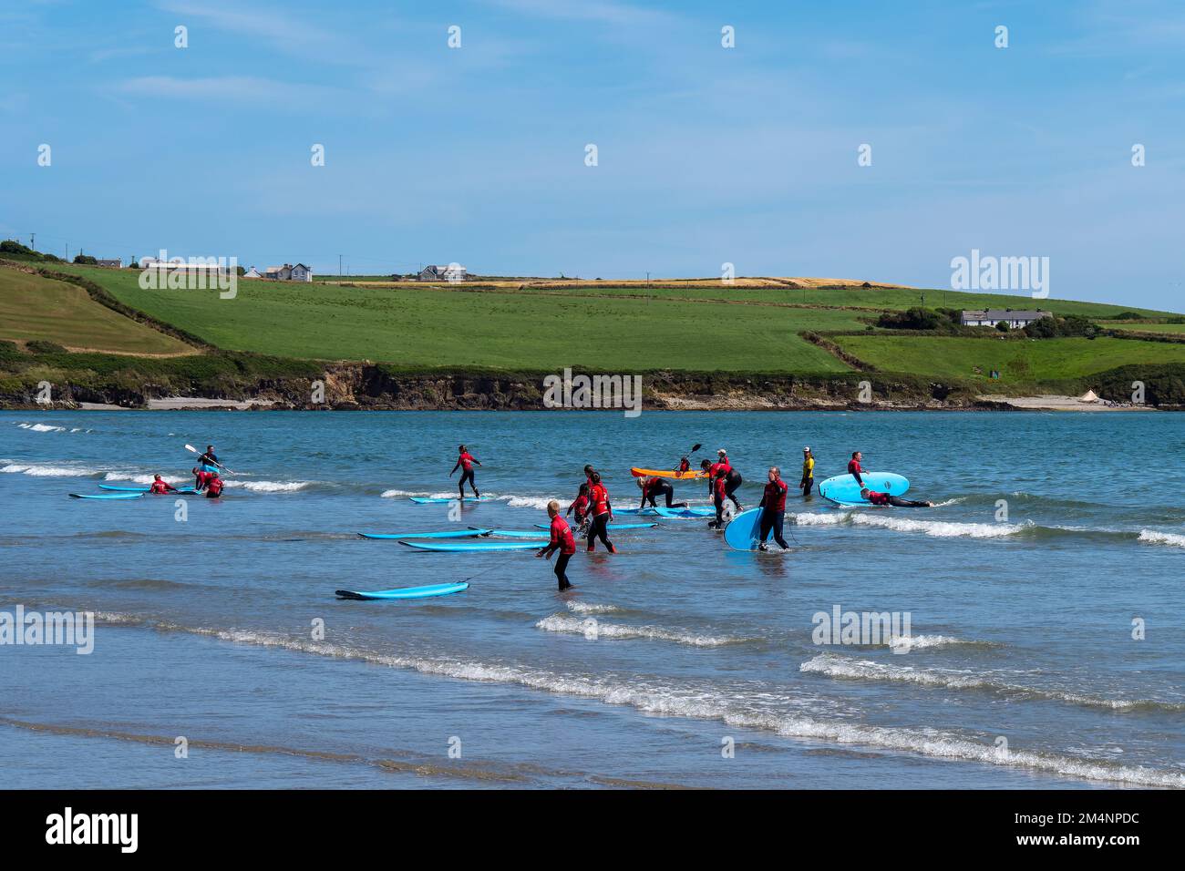 County Cork, Ireland, August 6, 2022. people are surfing. A surf school ...