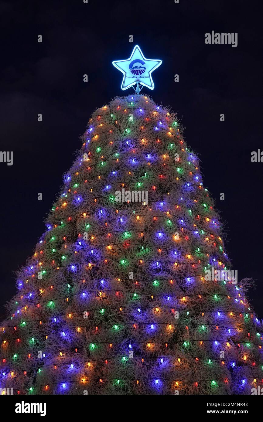 A Christmas tree made of tumbleweed wrapped in colorful lights and ...