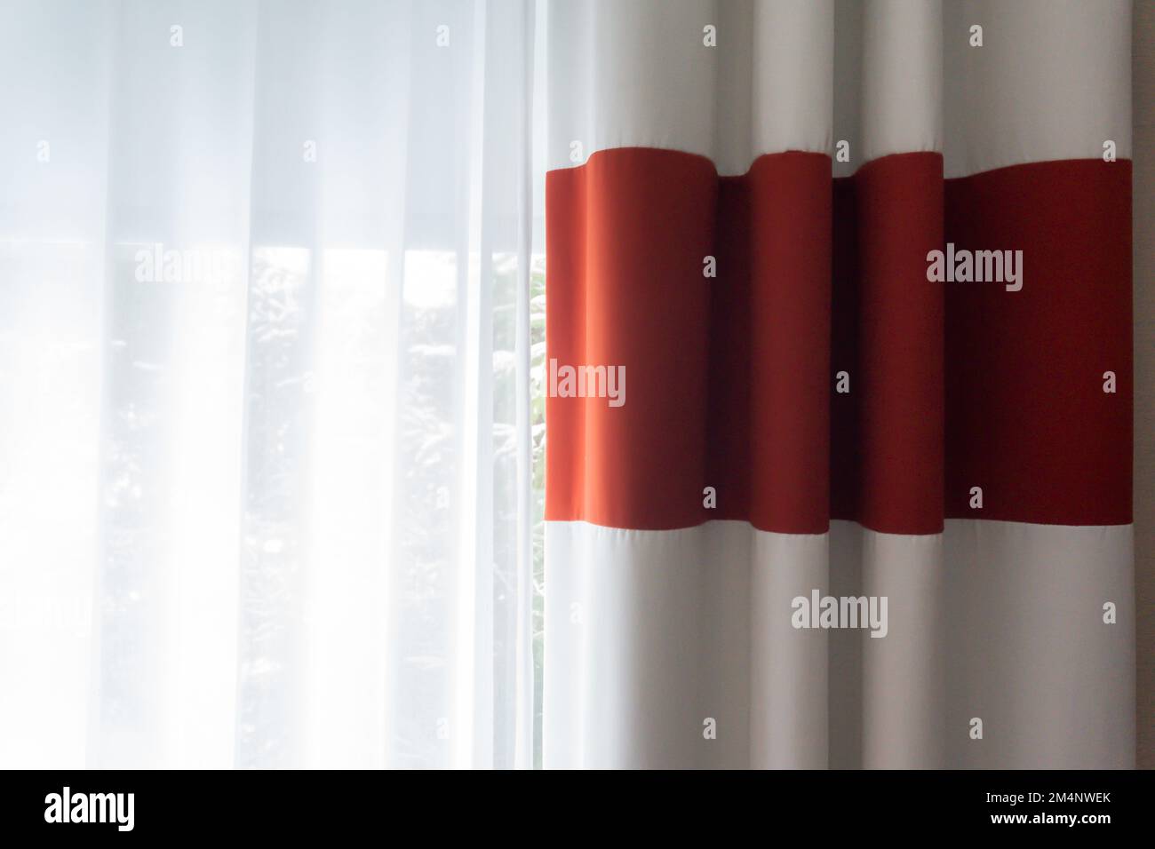 Sunlight through window and blinds falling on white curtain with red ...