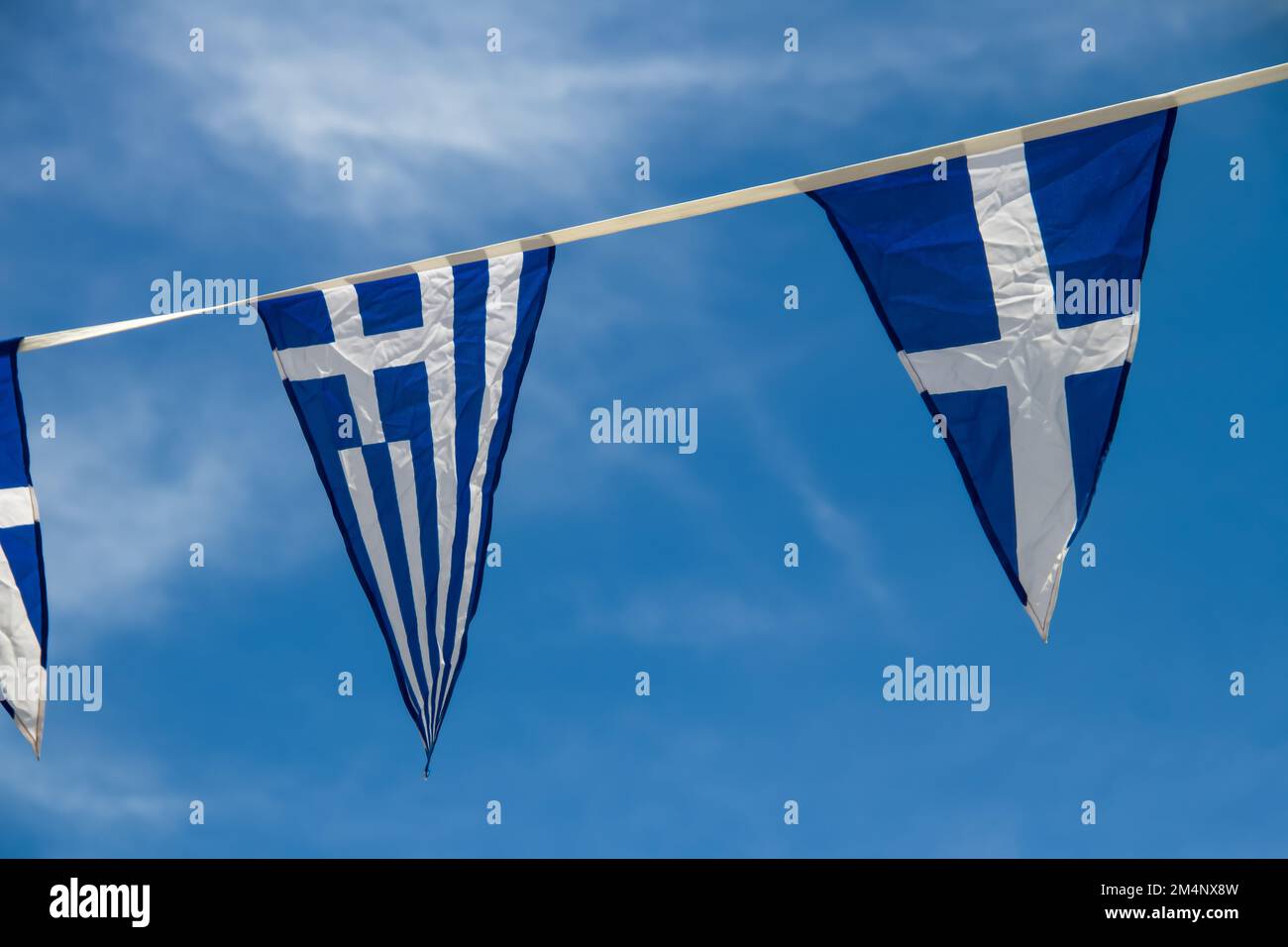 Greek national blue and white striped triangle flag hanging between ...