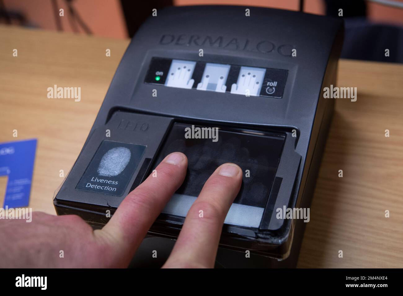 Berlin, Germany. 22nd Dec, 2022. A fingerprint is taken from a man in ...