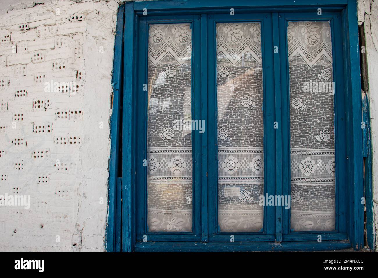 Typical white and blue painted frames of doors and windows with rusty ...
