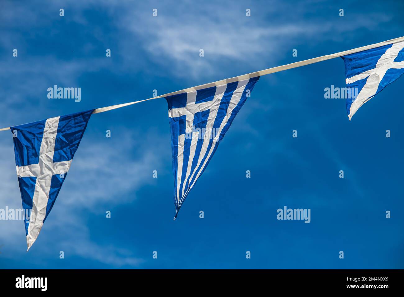 Greek national blue and white striped triangle flag hanging between ...