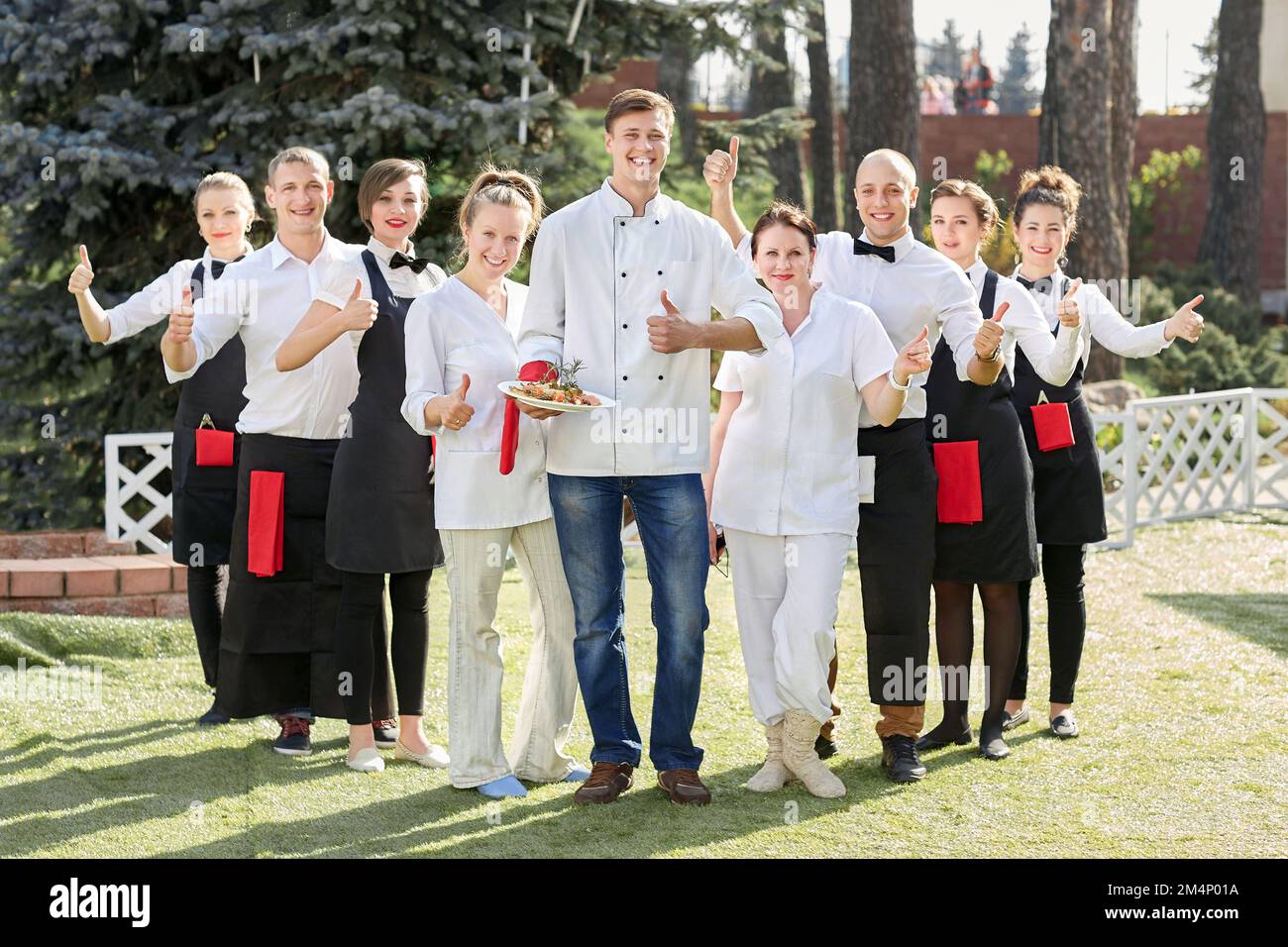 restaurant staff standing together and showing their thumbs up Stock ...