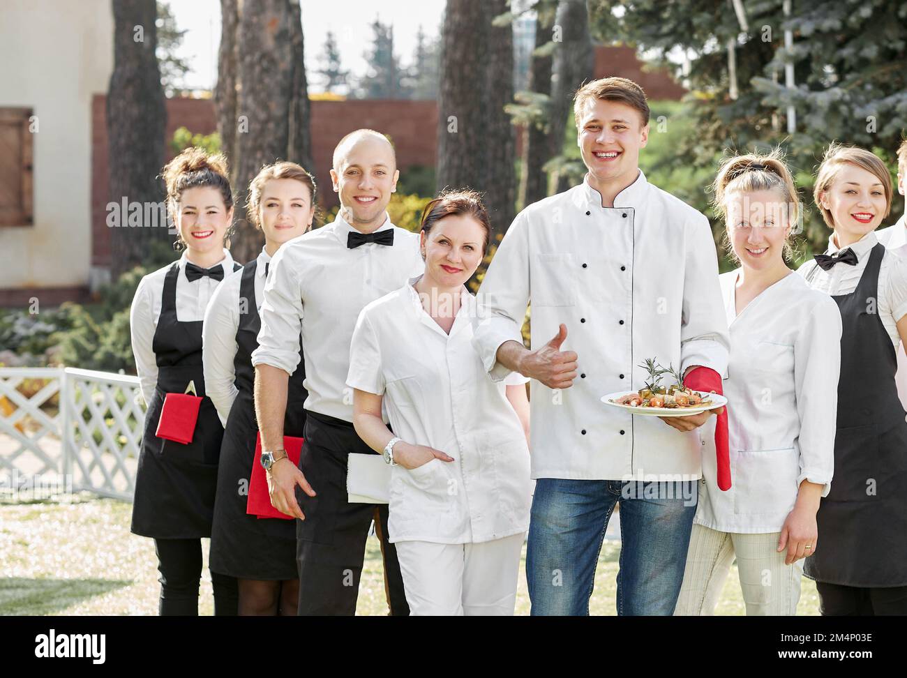 restaurant staff standing together and showing thumb up Stock Photo - Alamy