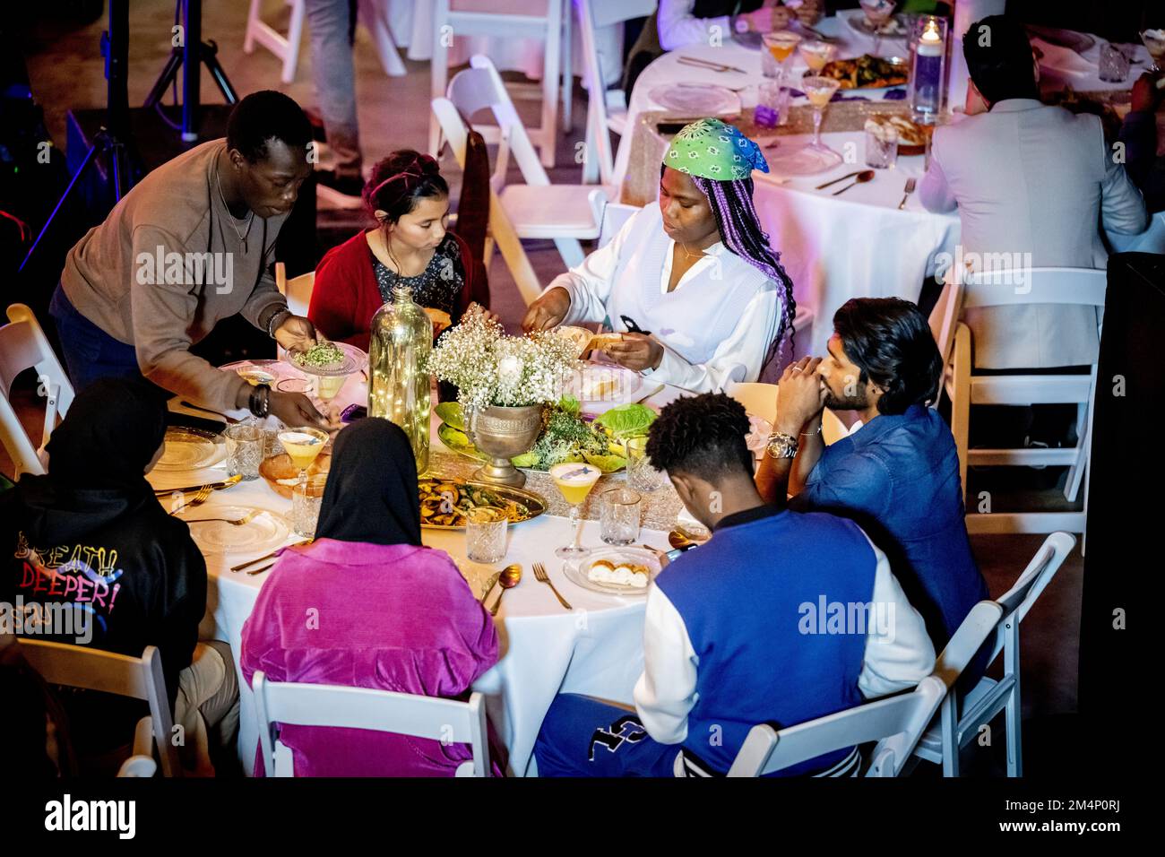 THE HAGUE - Visitors during a dinner for refugee youths. NPO FunX ...