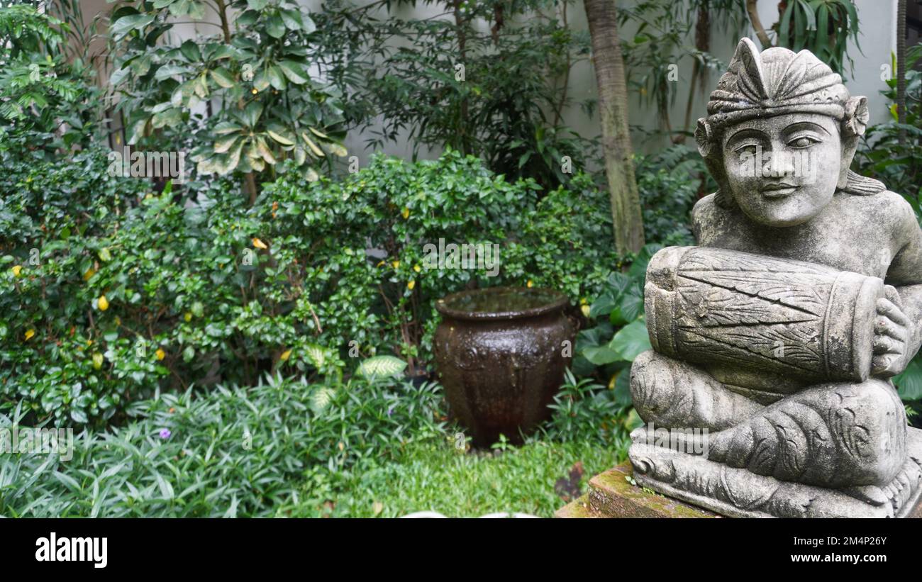 Calm quite Public park with statue on huge old tree. Greenery ...