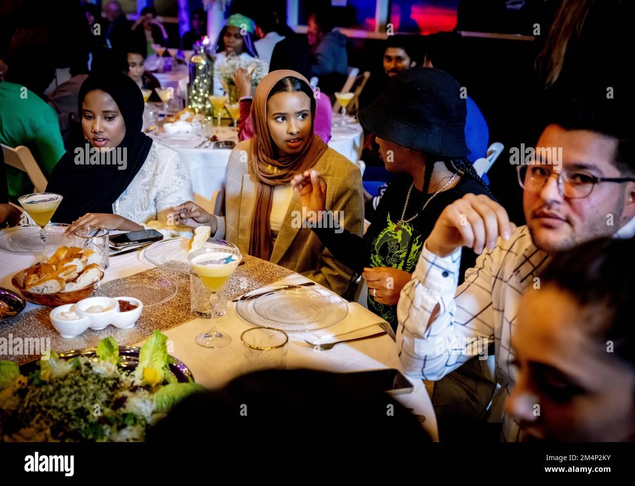 THE HAGUE - Visitors during a dinner for refugee youths. NPO FunX ...