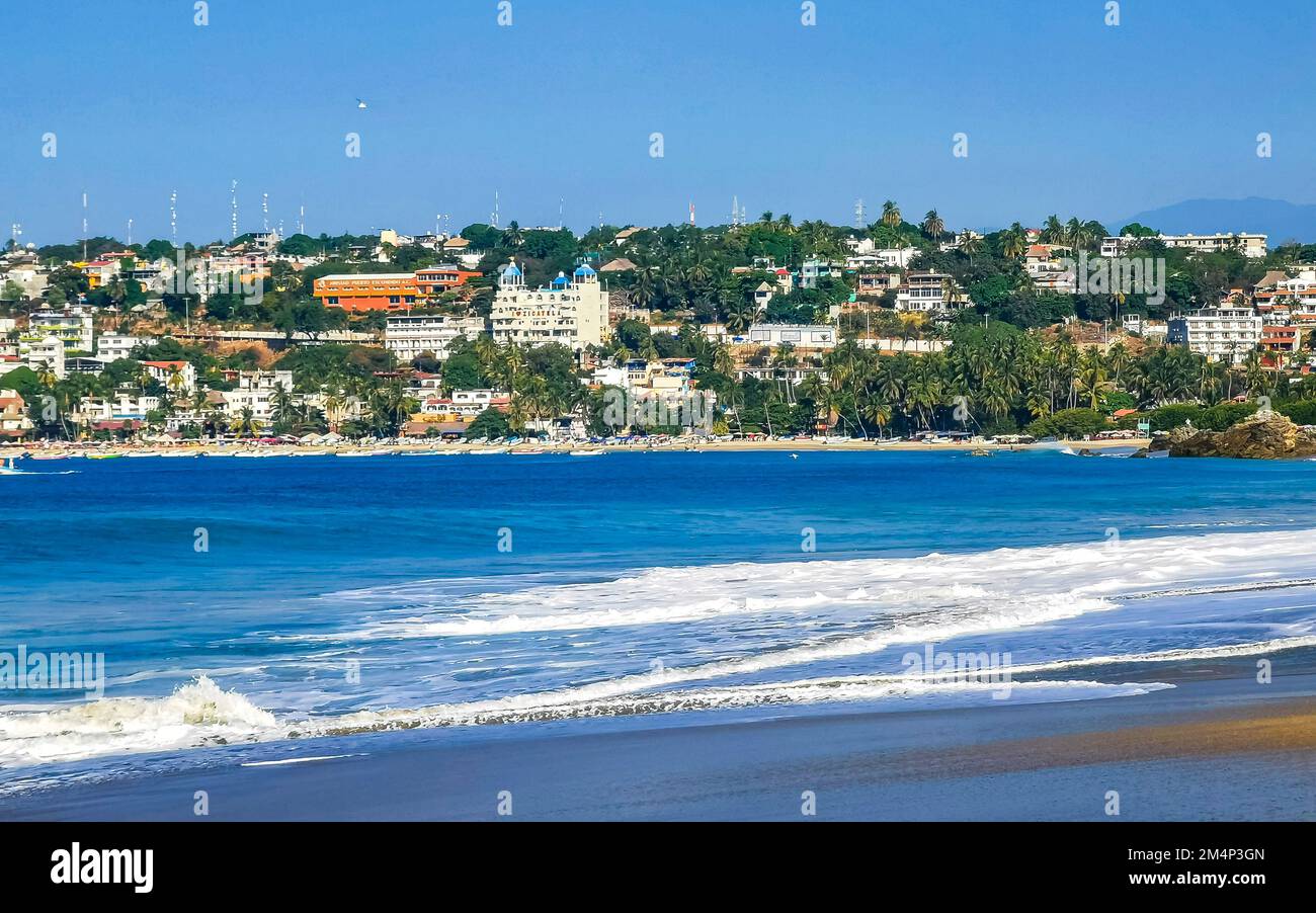 Beach sand blue water rocks cliffs and huge big surfer waves on the ...