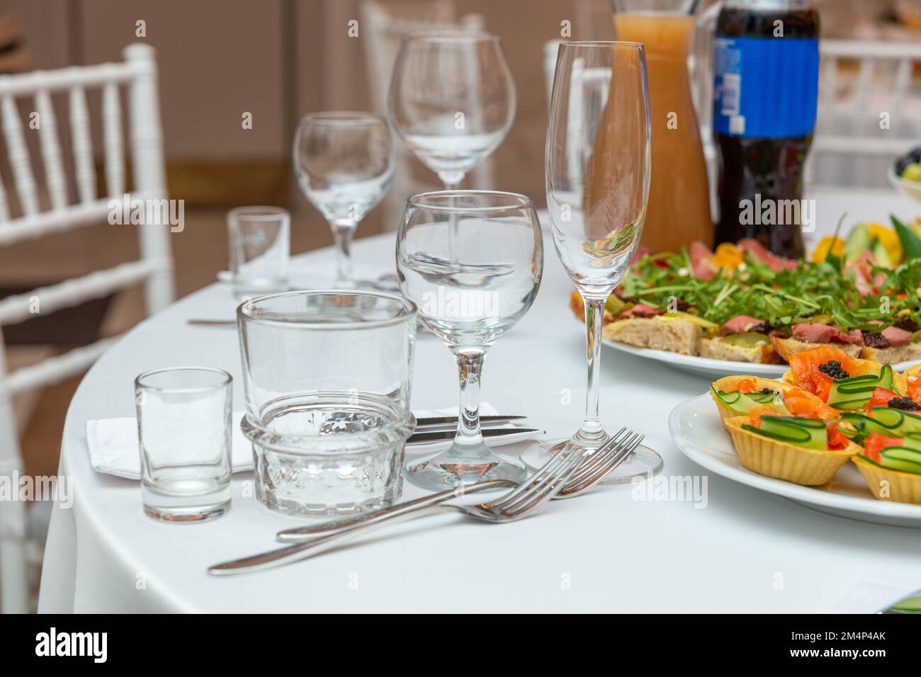 Served for holiday banquet restaurant table with dishes, snack, cutlery ...
