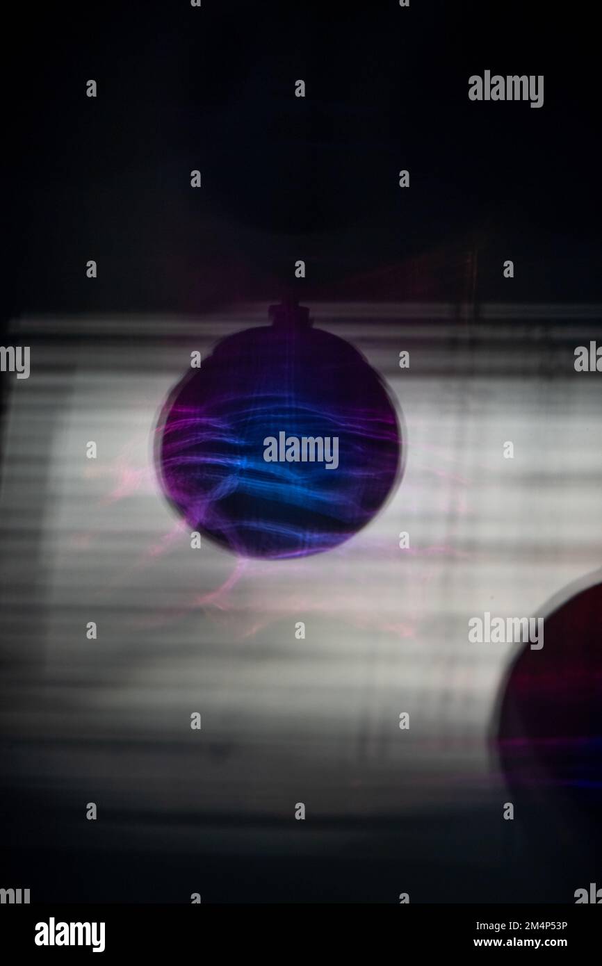 Glass hanging lights forming a colourful interesting shadow on a wall ...