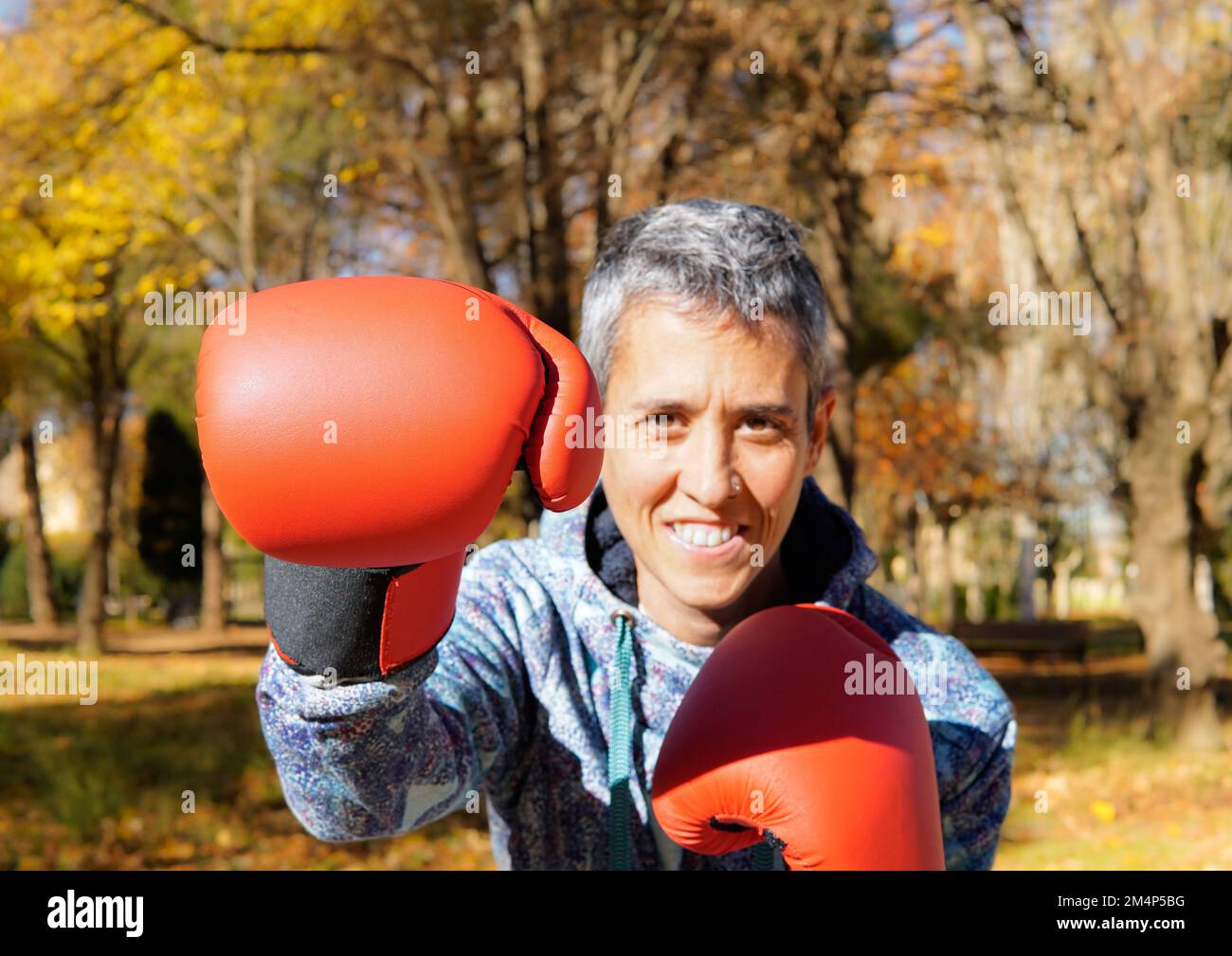 female boxer boxing with red boxing globes. Sportswoman training ...