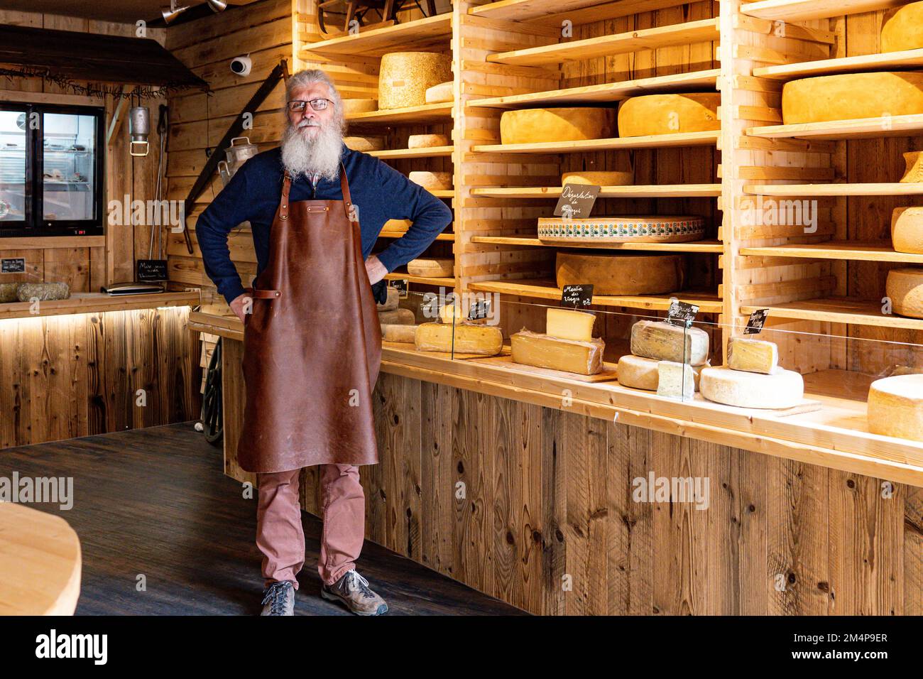 Cheeseman proudly displays cheese at L'Etable Fromagerie in Colmar ...