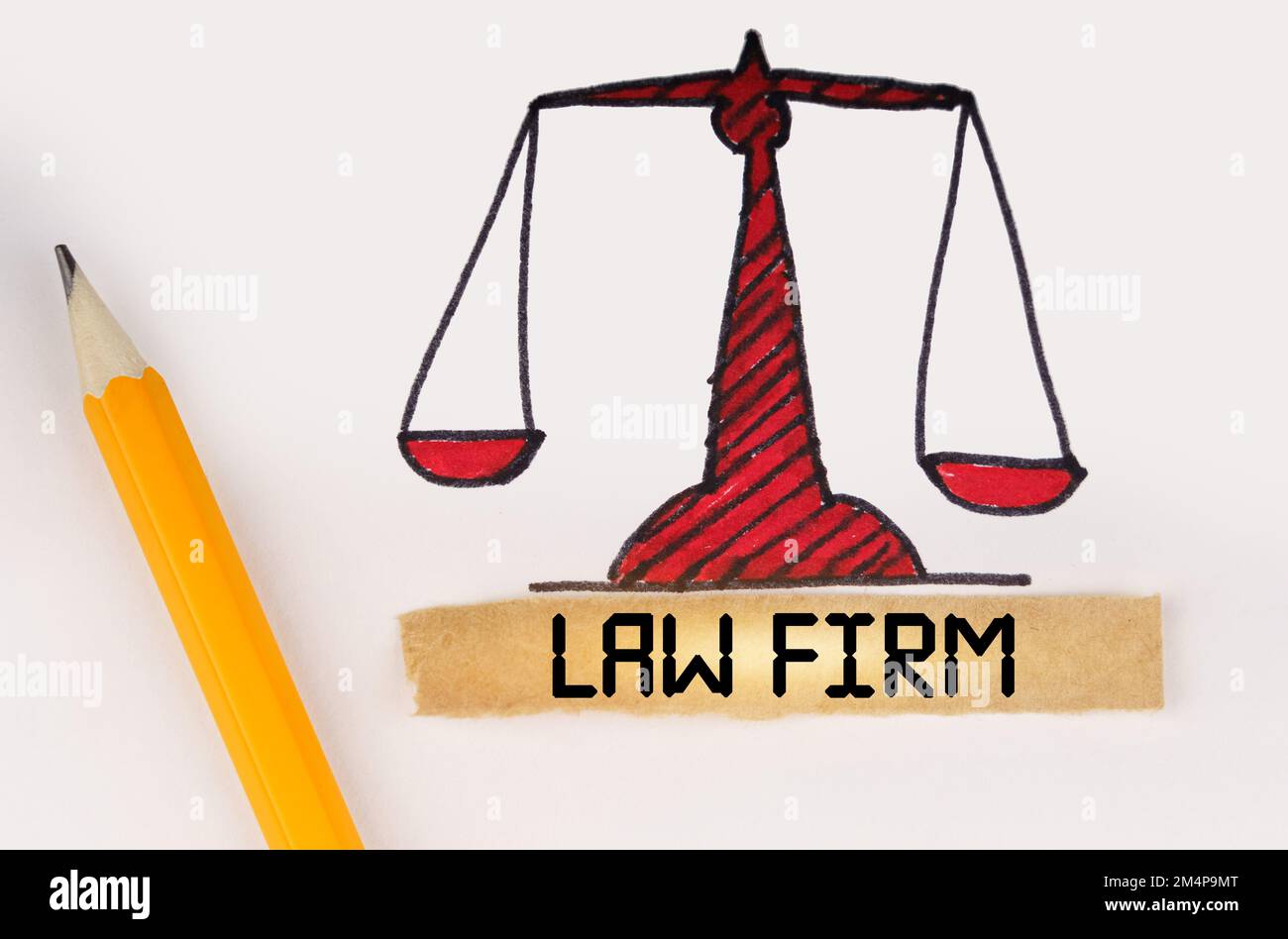 Legal concept. Next to the painted scales of justice lies a pencil and ...
