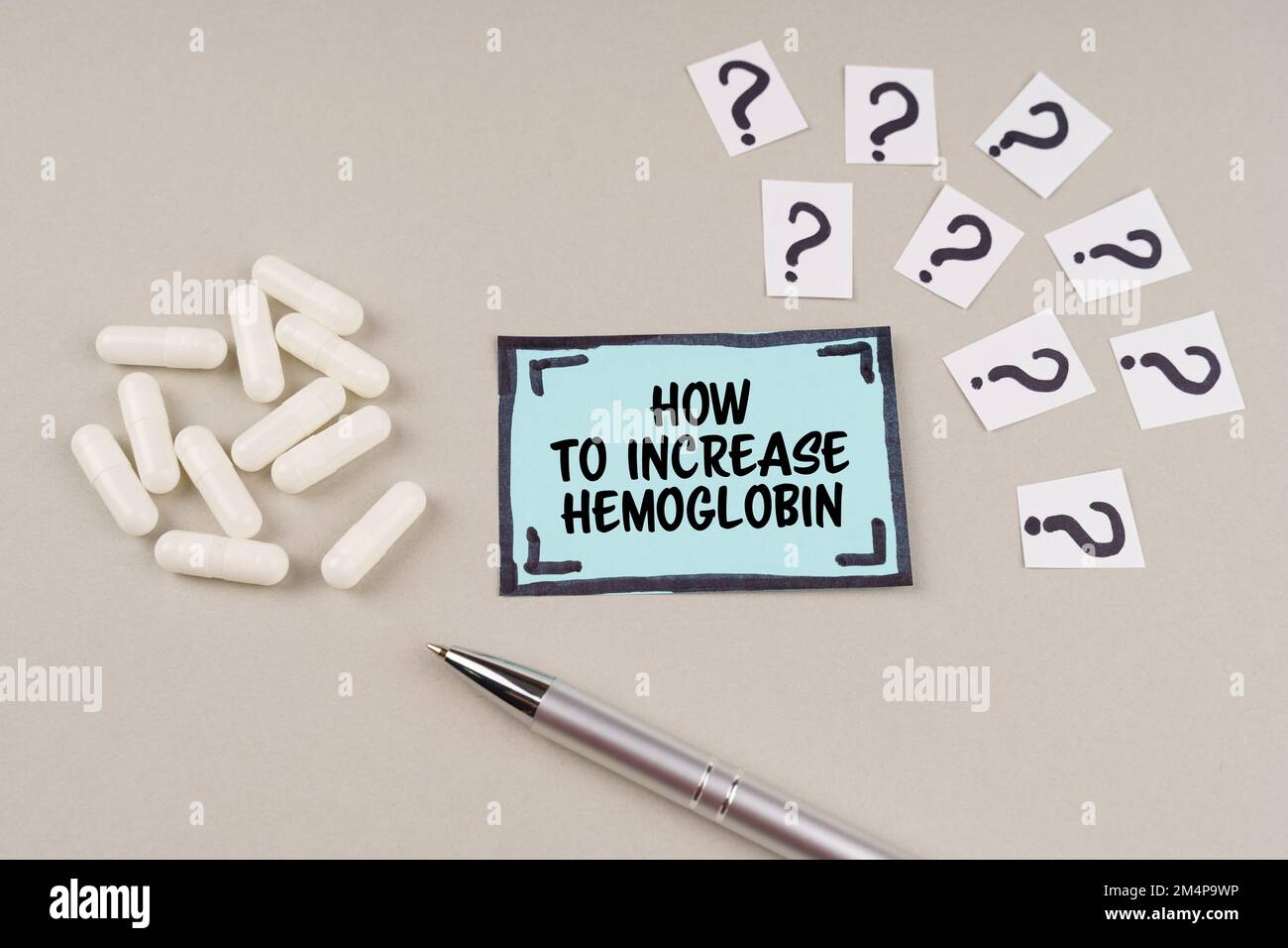 Medical concept. On a gray surface there are question marks and a blue ...