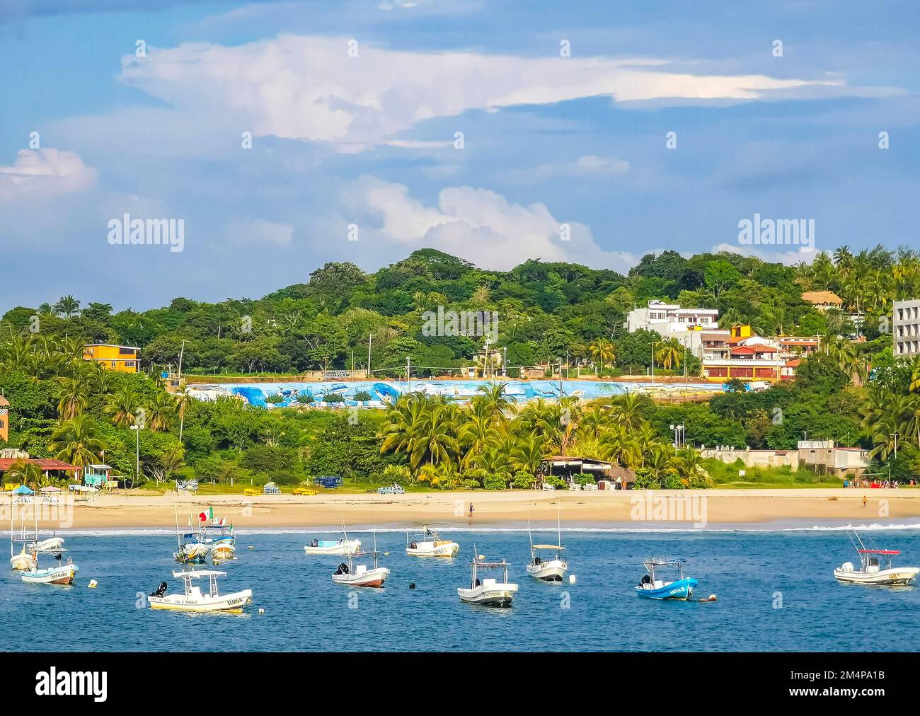 Fishing boats at the harbor and beach by Zicatela in Puerto Escondido ...