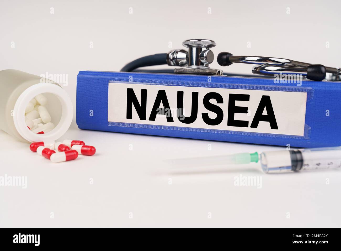 Medical concept. On a white surface there are pills, a syringe, a ...