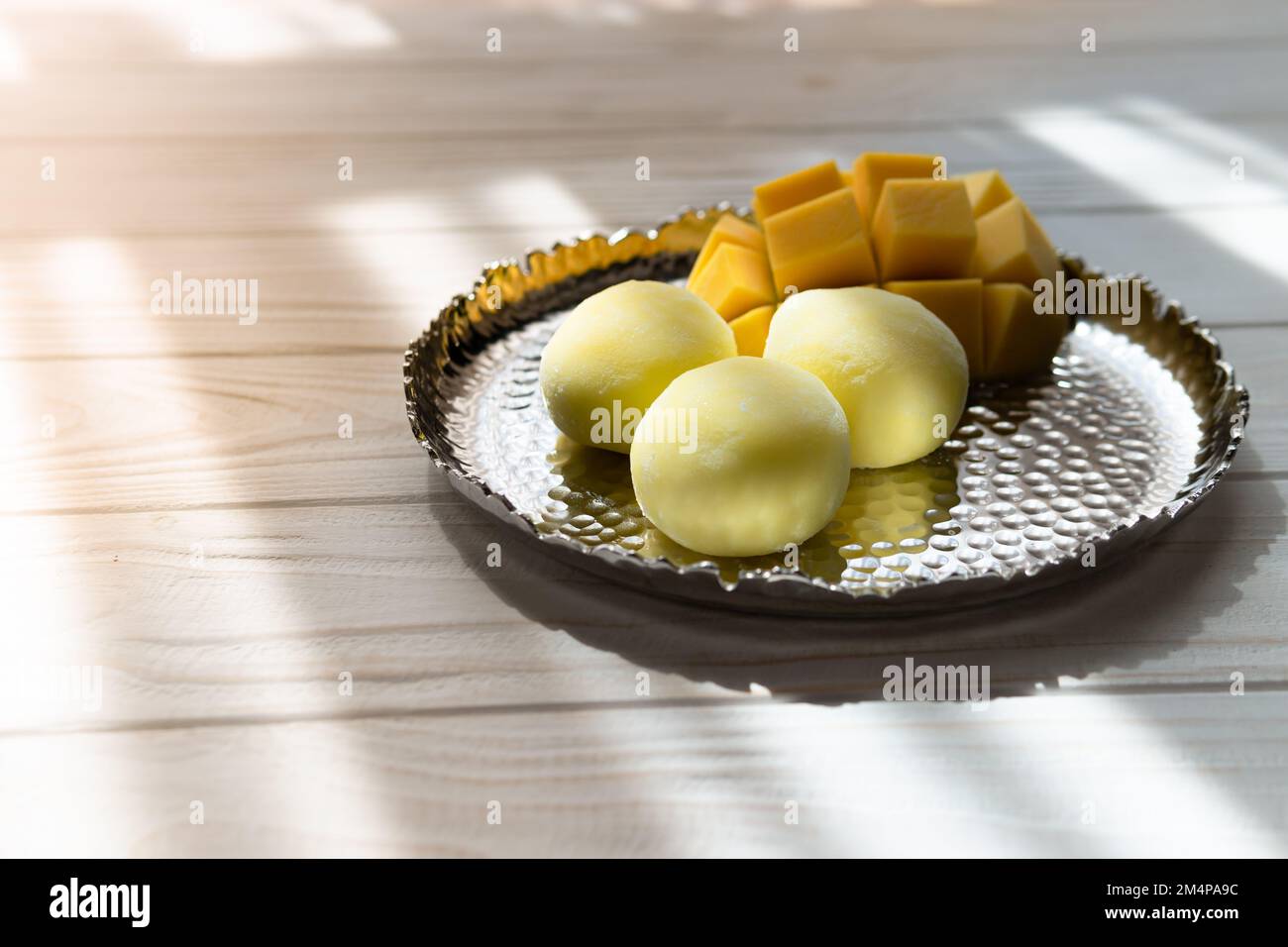 Tasty dessert Mochi with mango fruit on wooden background, close up ...