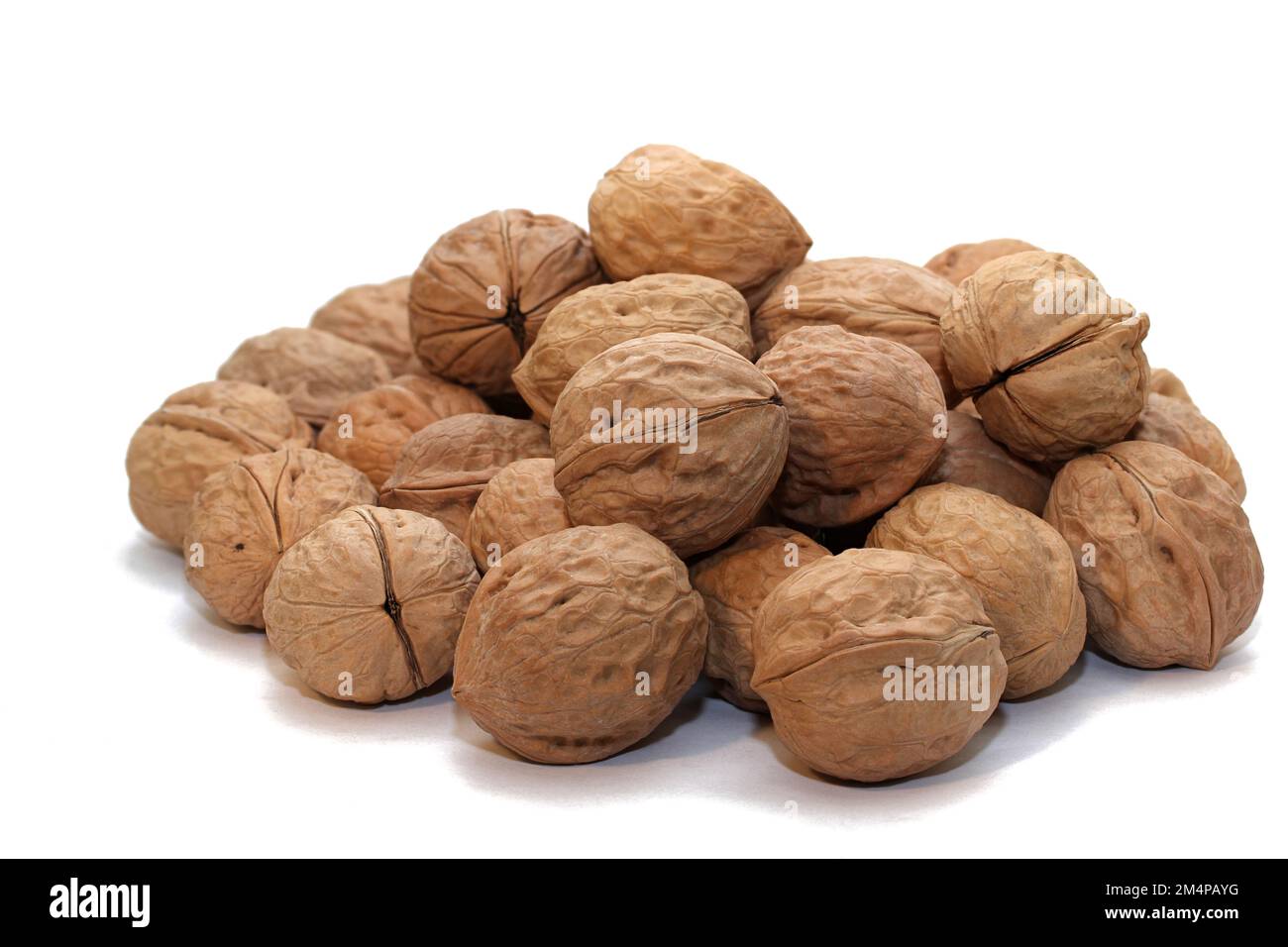 Pile of closed walnuts isolated on white background Stock Photo - Alamy