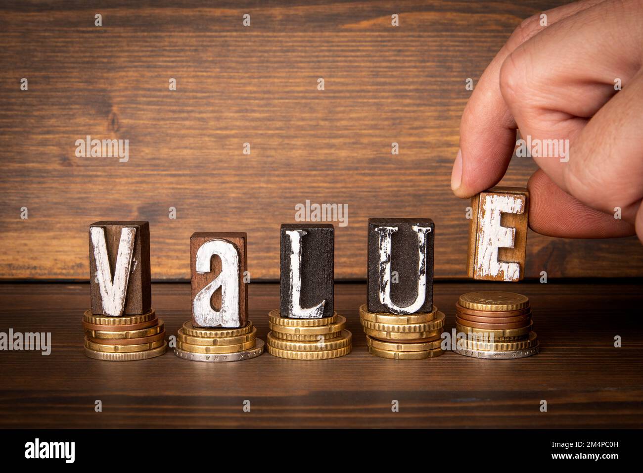 Value concept. Text and money on wood texture background Stock Photo ...