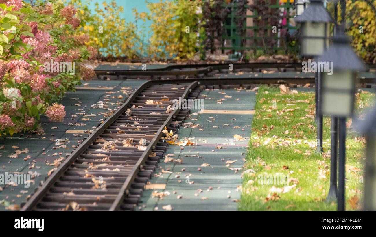 Outdoor entertainment railway attraction with lamp lanterns. Railway in ...