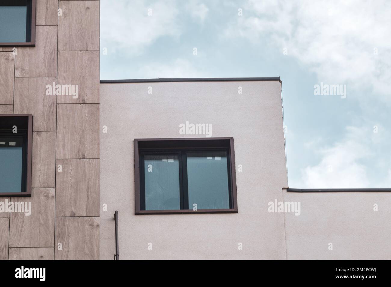 Modern residential building facade architecture. Tiled and white walls ...