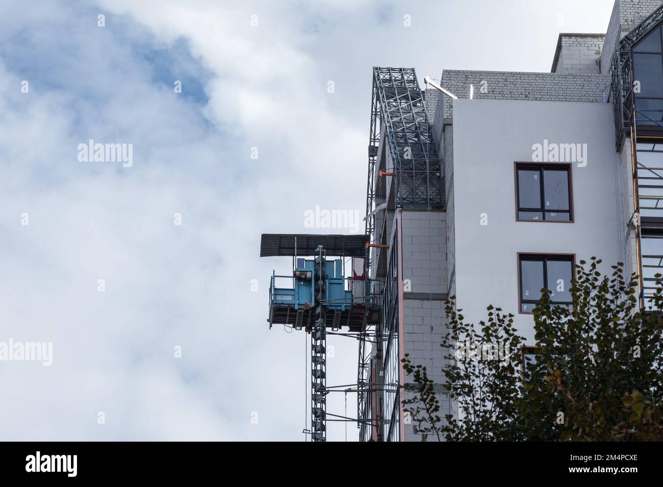 Multistory white brick building construction site, outdoor facade with ...
