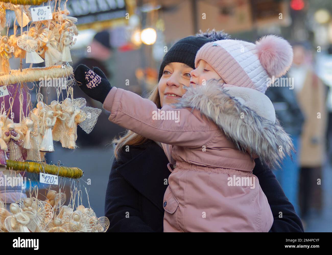 Prague - December 13: A young woman and her young daughter in winter ...