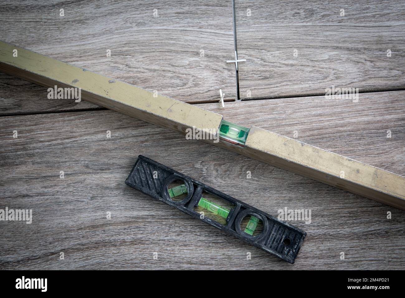 Spirit level tool or bubble levels at construction site. Laying ceramic ...