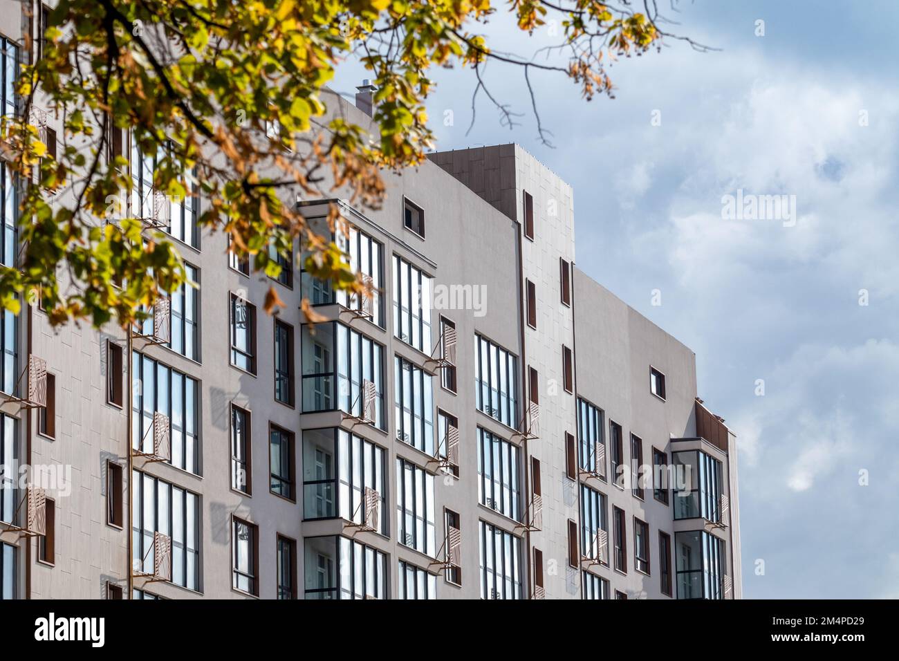 Modern residential building facade architecture with tree branches ...