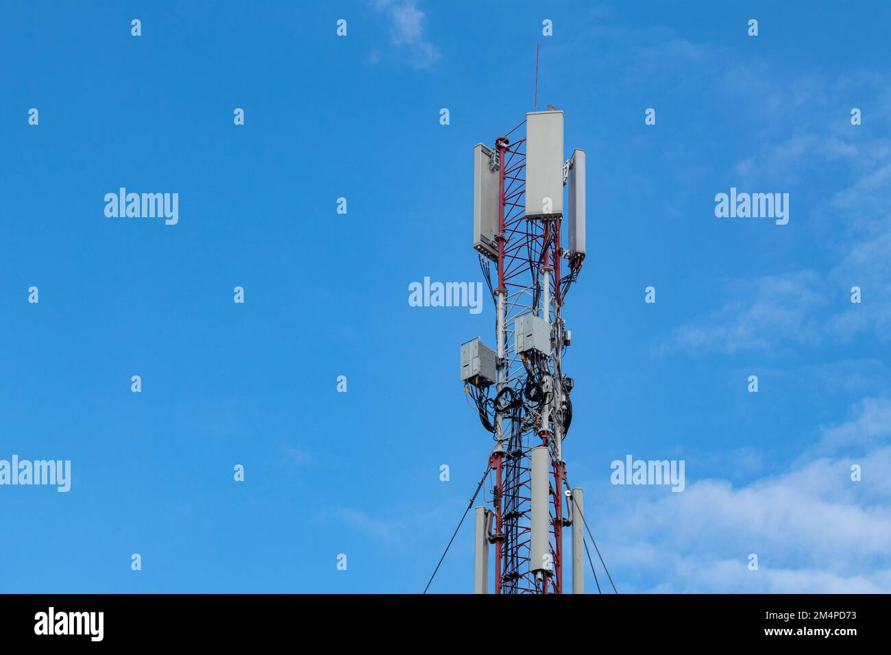 Mobile or cell tower with antennas and electronic equipments on blue sky. Broadband transmission ...