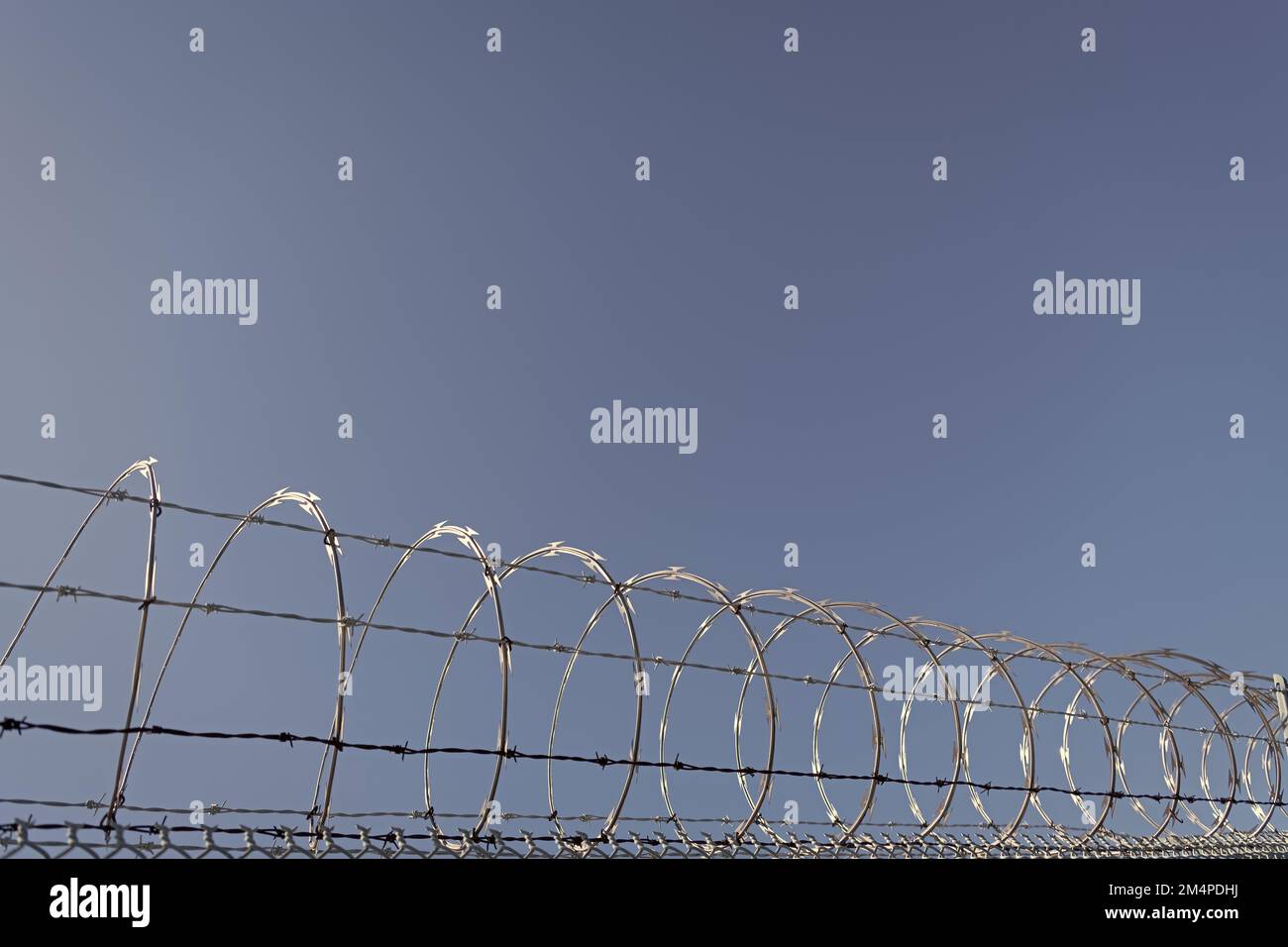 barbwire prison wall with barbed wire fence coiled razor wire perimeter ...