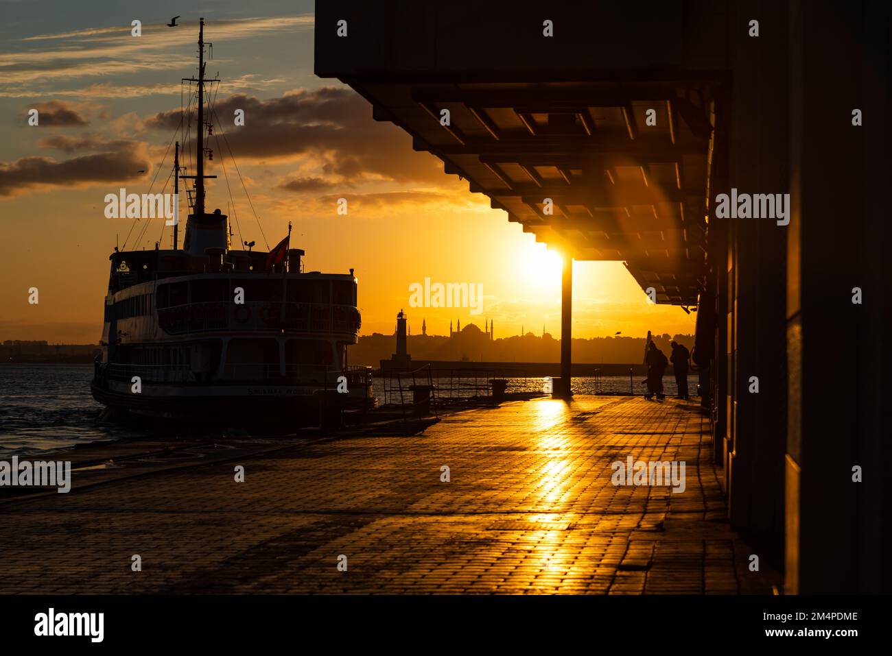 ferry docked at the pier at sunset , ship carrying passengers on the ...