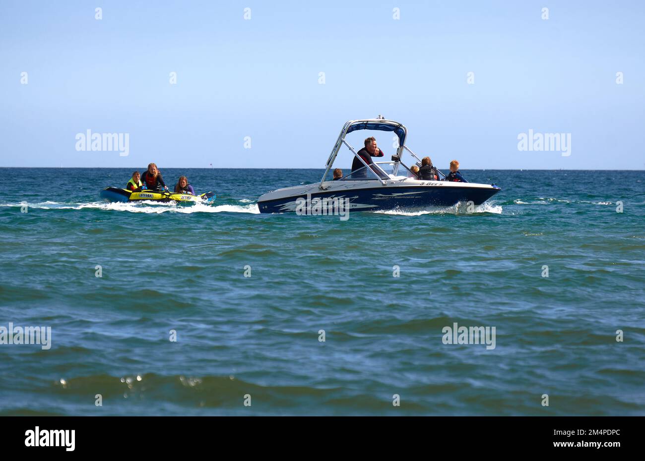 Speedboat towing people at sea Stock Photo - Alamy