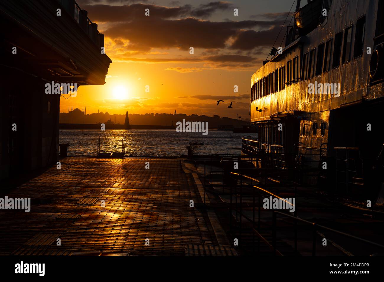 ferry docked at the pier at sunset , ship carrying passengers on the ...