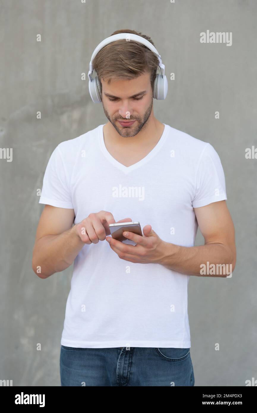 photo of busy man mp3 music playlist in headphones. man open mp3 music ...